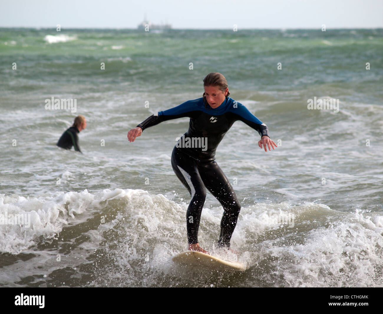 A surfer rides waves in the sea near to Brighton,England Stock Photo ...