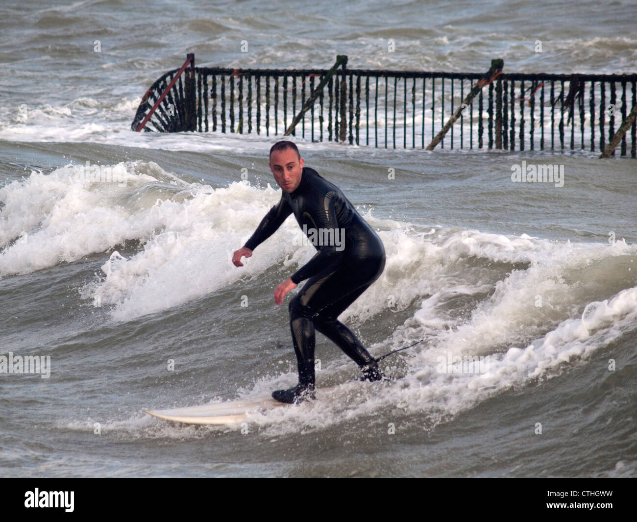 A surfer rides waves in the sea near to Brighton,England Stock Photo ...