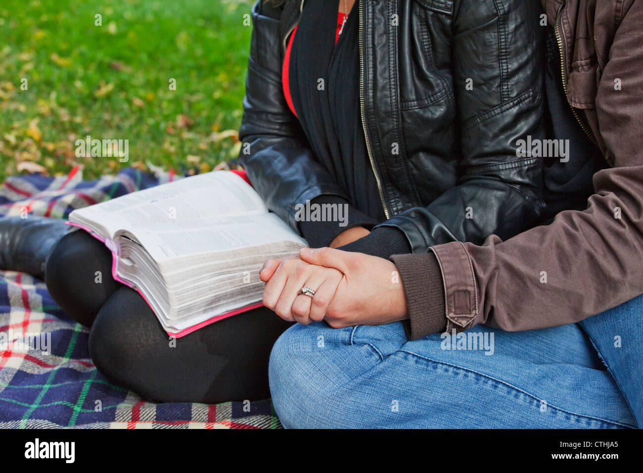 Praying hands couple reading bible hi-res stock photography and images ...