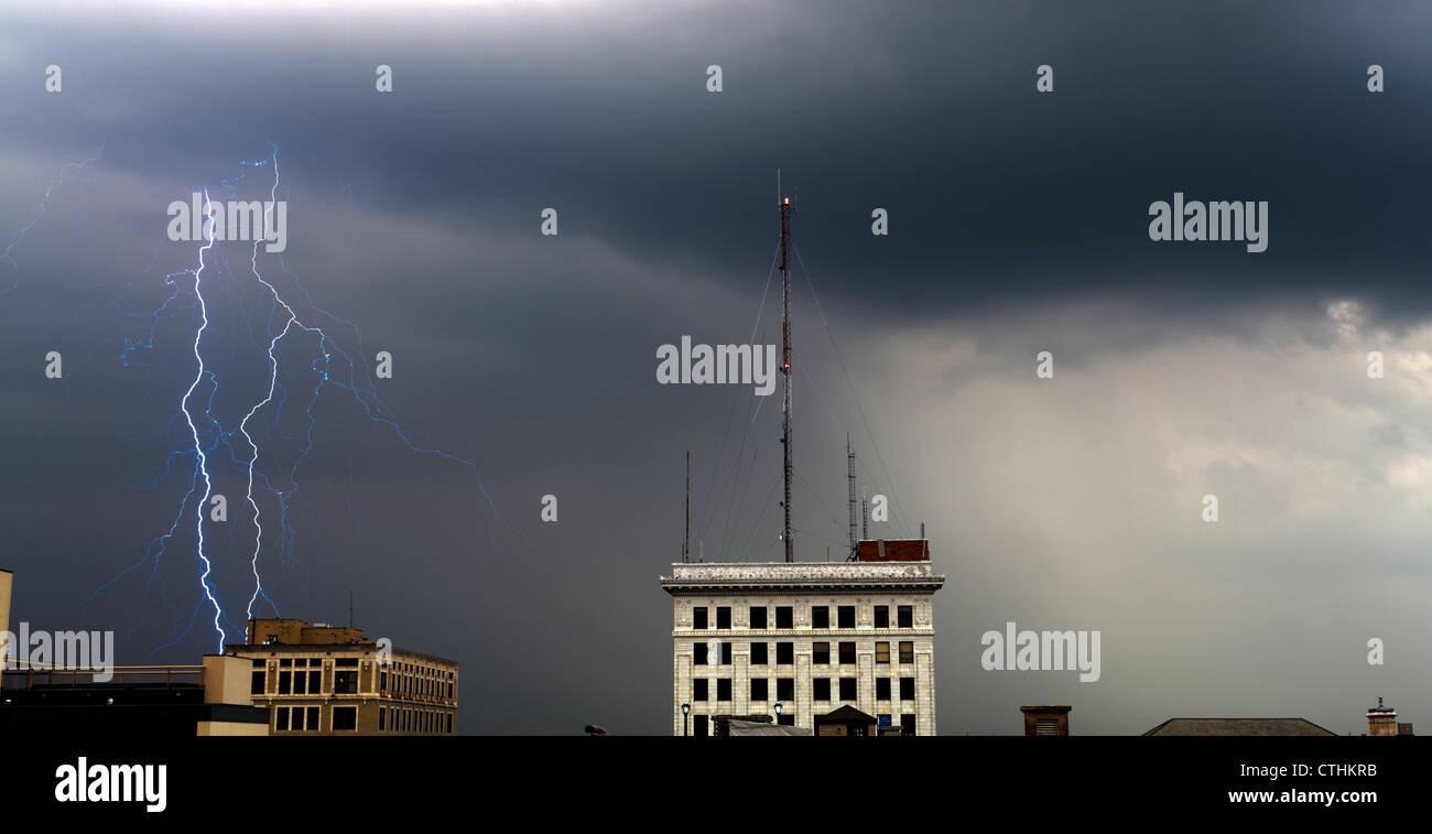 Lightning strikes behind buildings in a city Stock Photo - Alamy