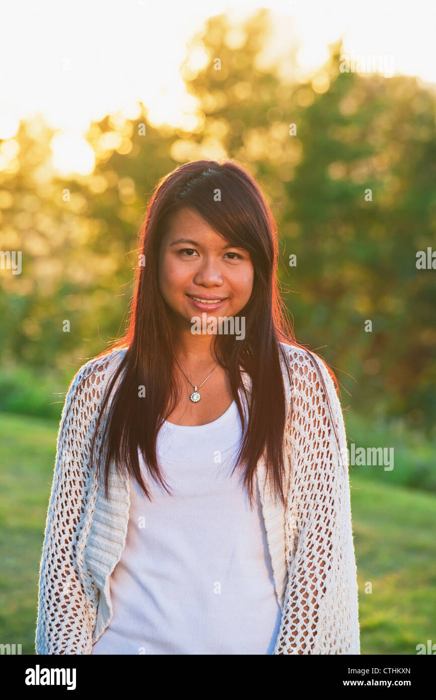 Portrait Of A Young Filipino Woman In A Park; Edmonton, Alberta, Canada ...