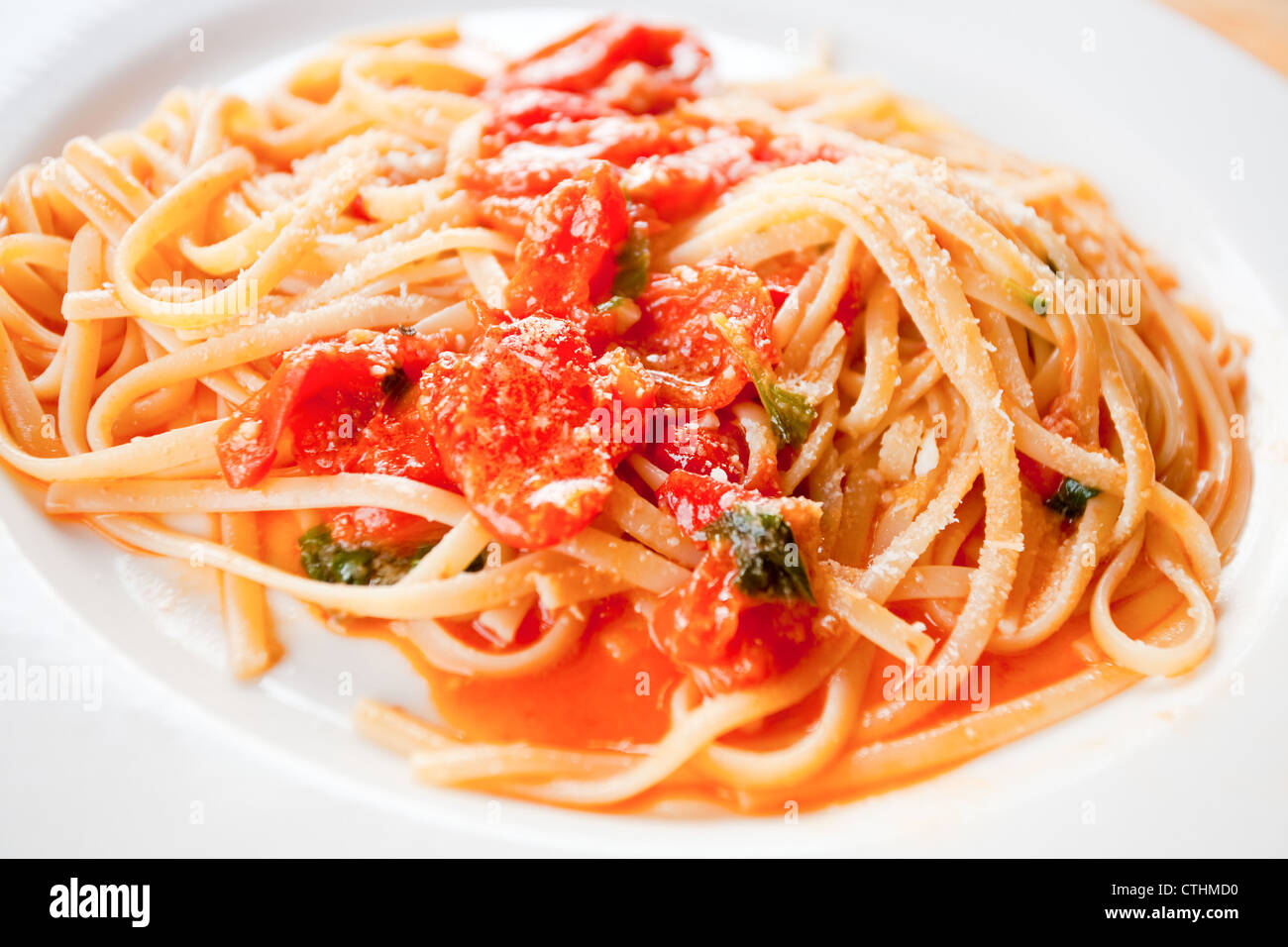 spaghetti with spicy tomato sauce on white plate closeup Stock Photo ...
