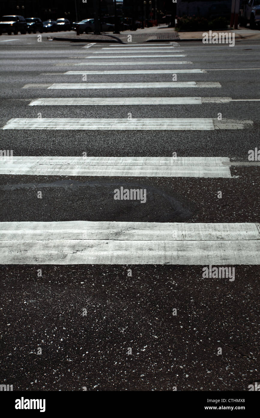 Crosswalk stripes on blacktop road Stock Photo - Alamy