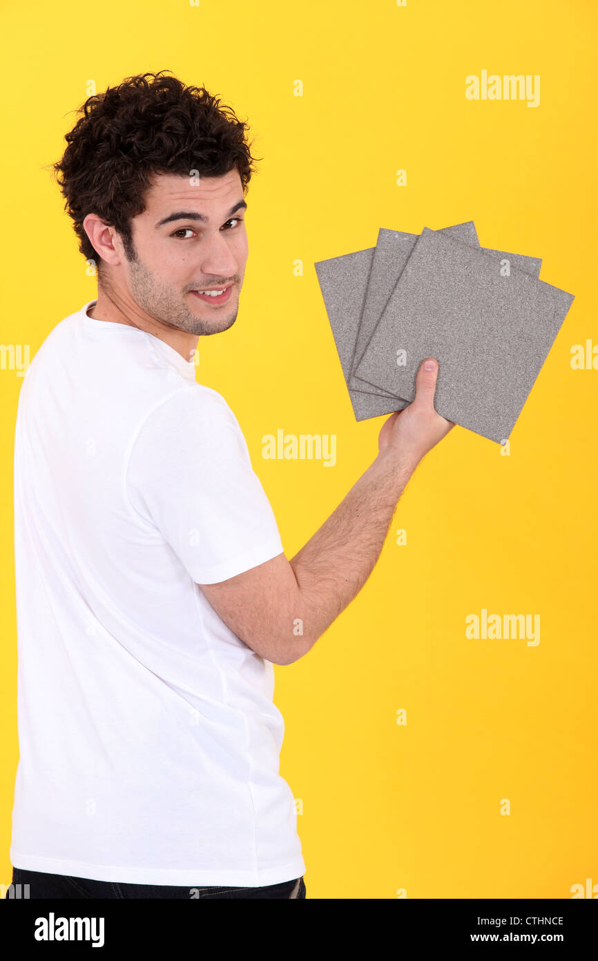 Man holding bathroom tiles Stock Photo - Alamy