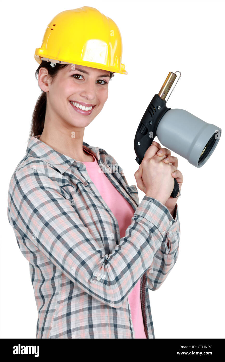 Woman holding blow-torch Stock Photo - Alamy