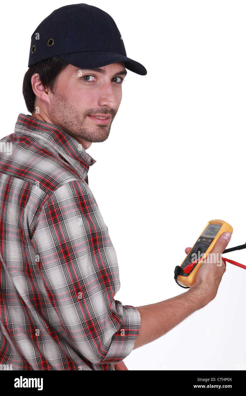 Tradesman holding a multimeter Stock Photo - Alamy