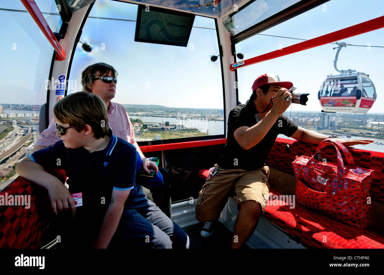 Emirates Air Line cable car, London - passengers enjoy the view and ...