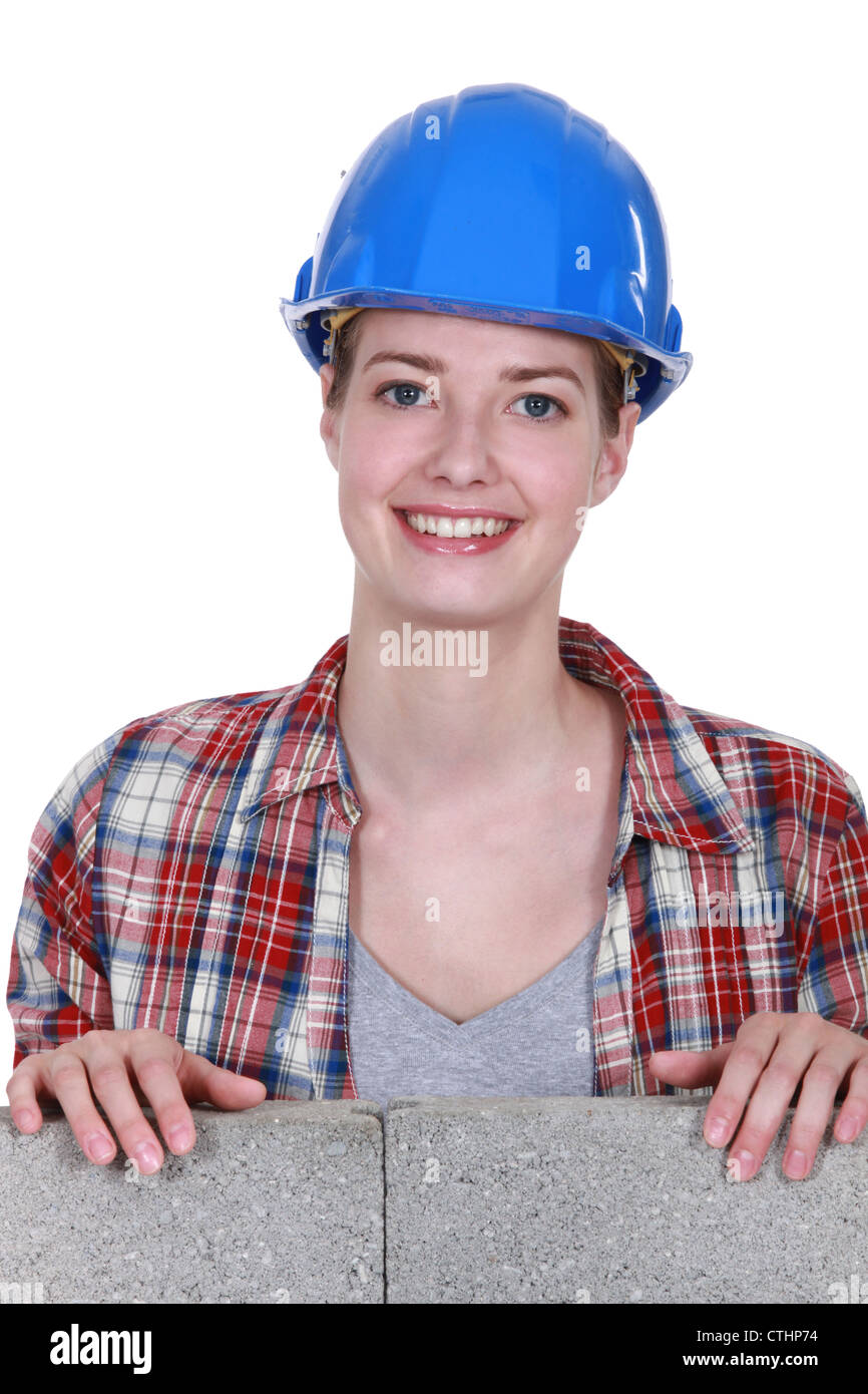 Female mason leaning on wall Stock Photo - Alamy
