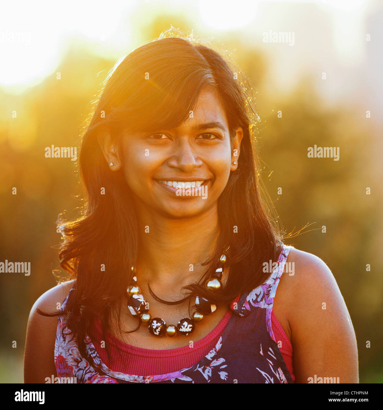 Portrait Of A Young Woman In A Park At Sunset; Edmonton, Alberta ...