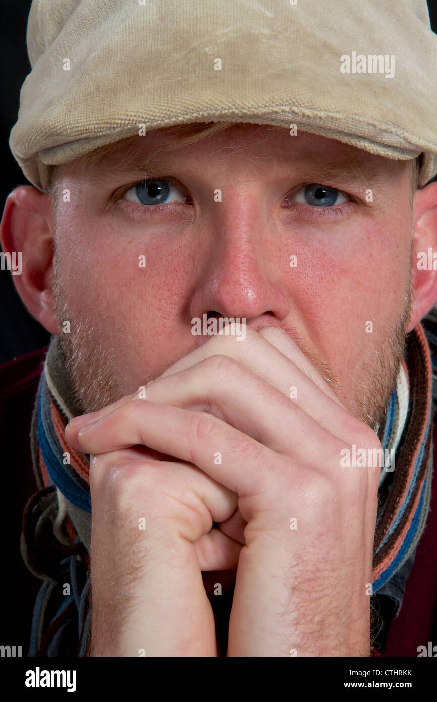 Portrait of a young man with cap thinking Stock Photo - Alamy