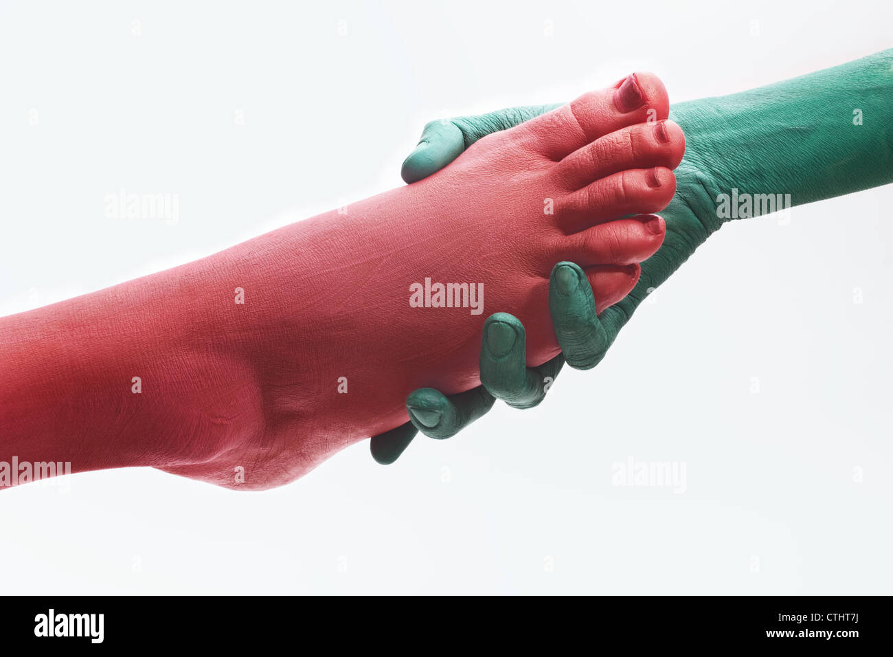 Hand holding a leg up on a white background Stock Photo - Alamy