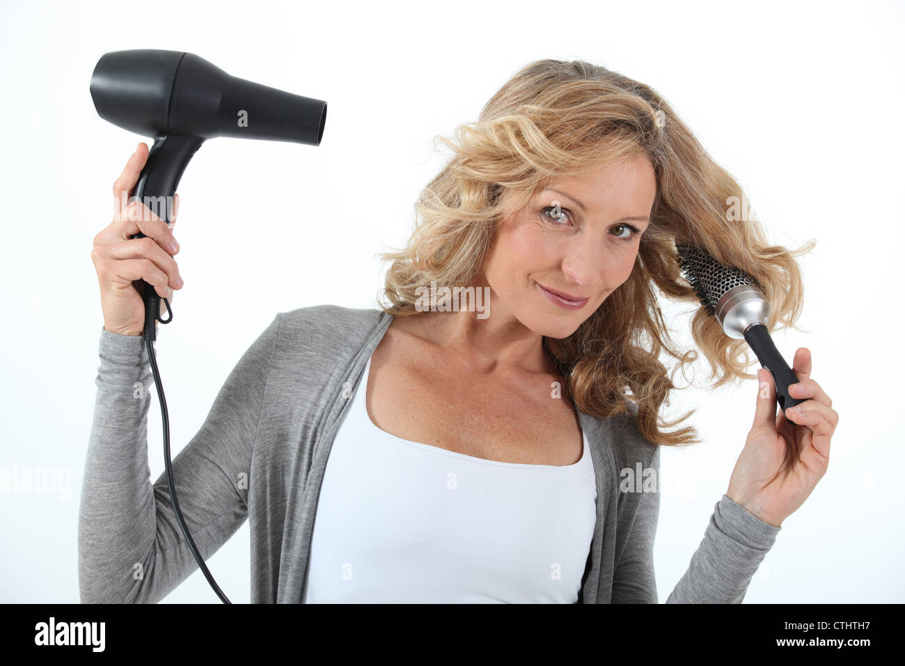Woman drying hair Stock Photo - Alamy