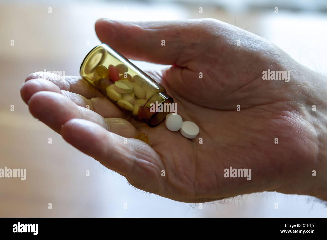 Senior man looking pill bottle hi-res stock photography and images - Alamy