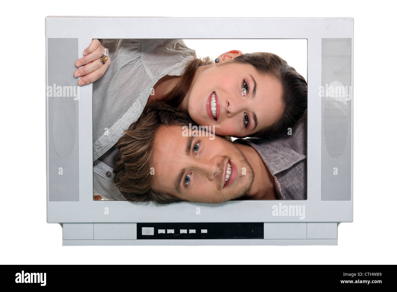 Young people passing heads through TV screen Stock Photo - Alamy