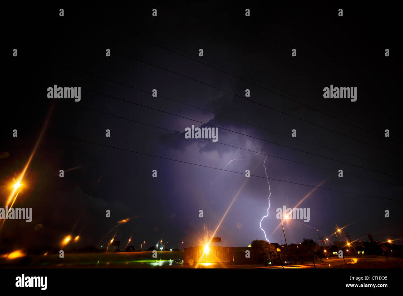 A lightning strike above a city at night Stock Photo - Alamy