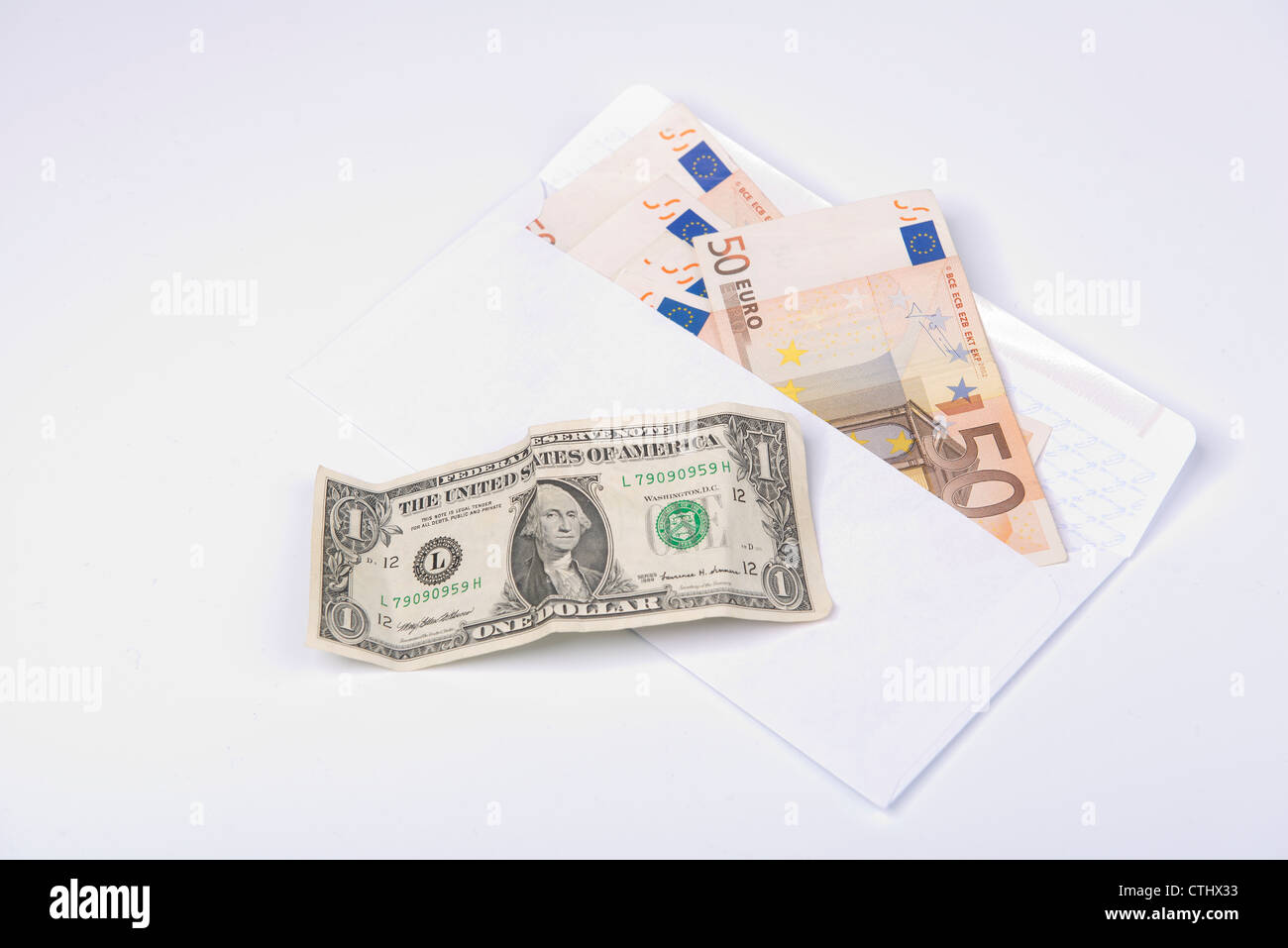 Some euro banknotes inside an envelope with upon a dollar banknote ...