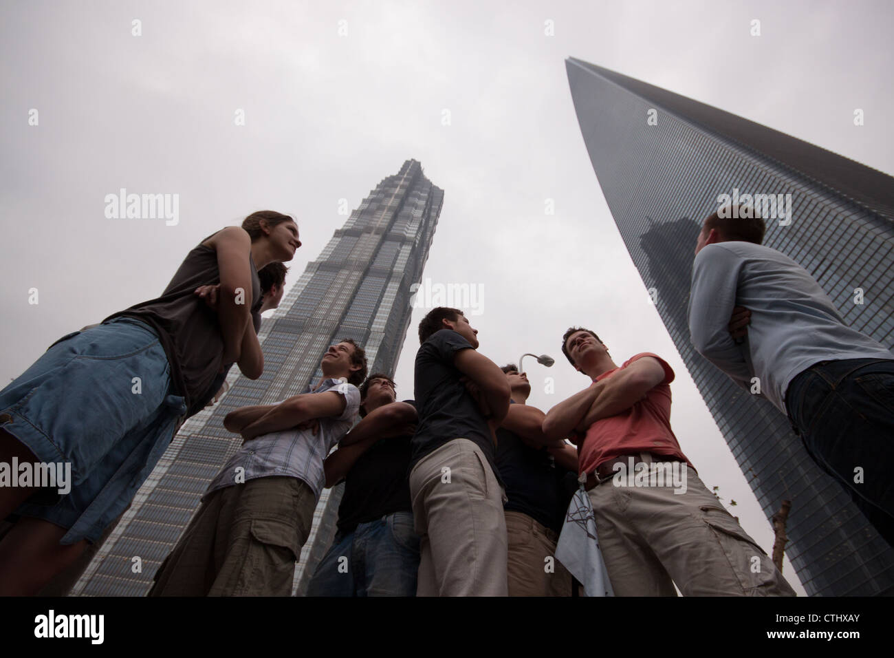 people posing next to high rise Stock Photo - Alamy