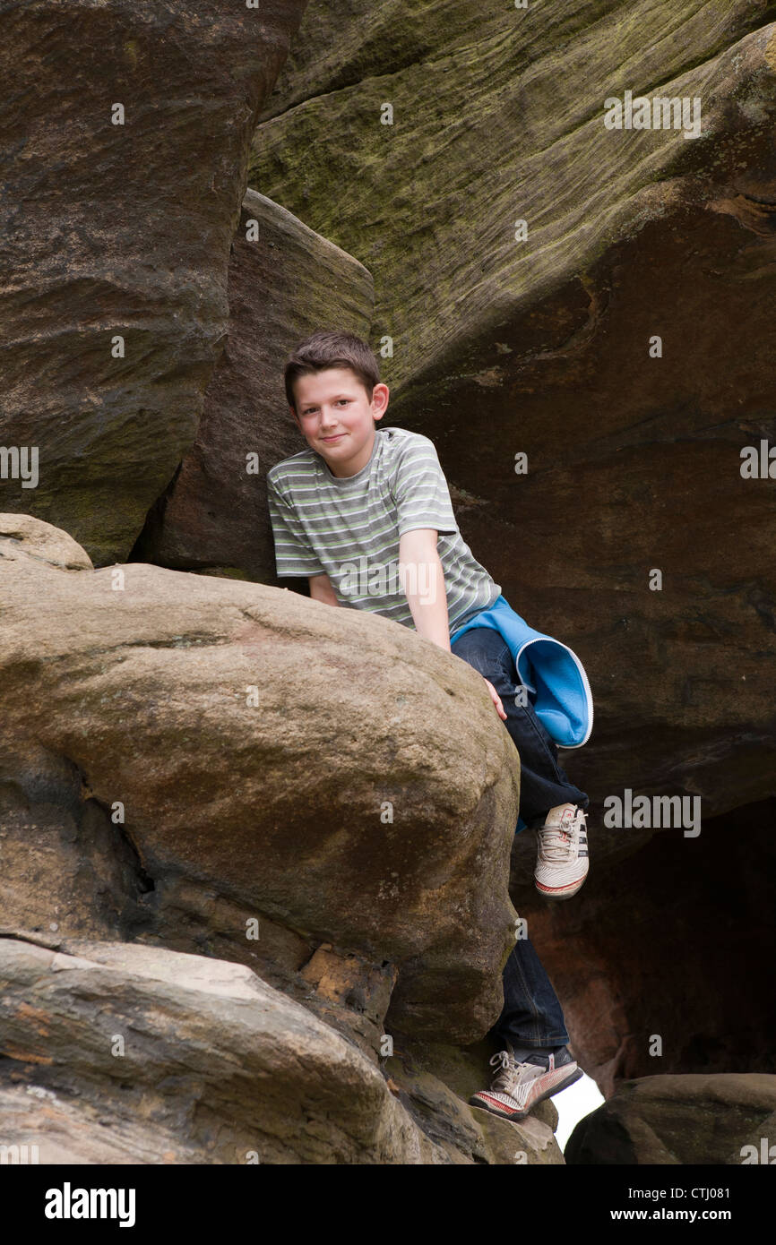 Young boy rock climbing at Brimham rocks Summerbridge, Harrogate, North ...