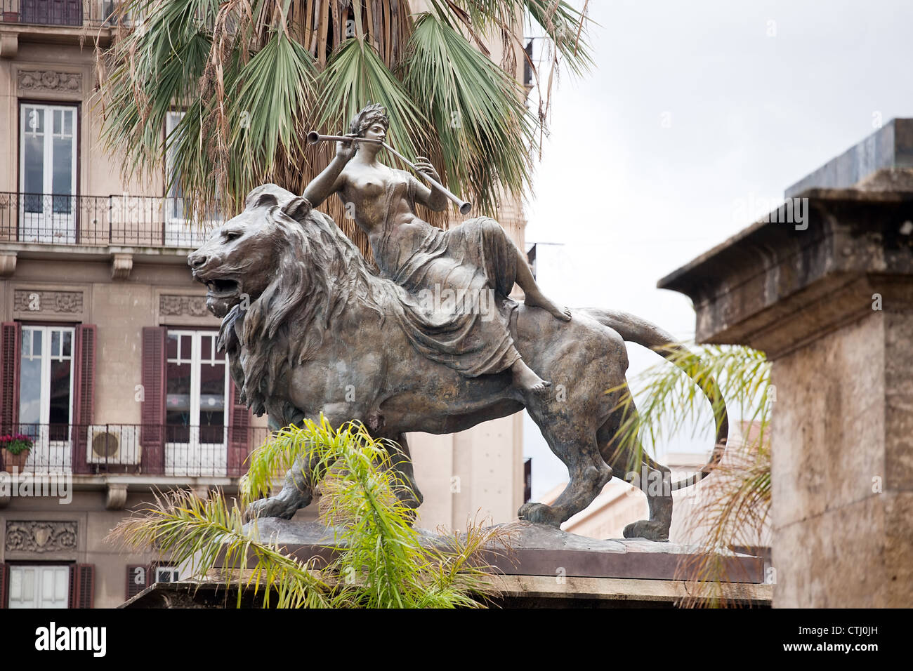 Statue of lyric opera (woman on a lion) standing before Teatro Massimo ...
