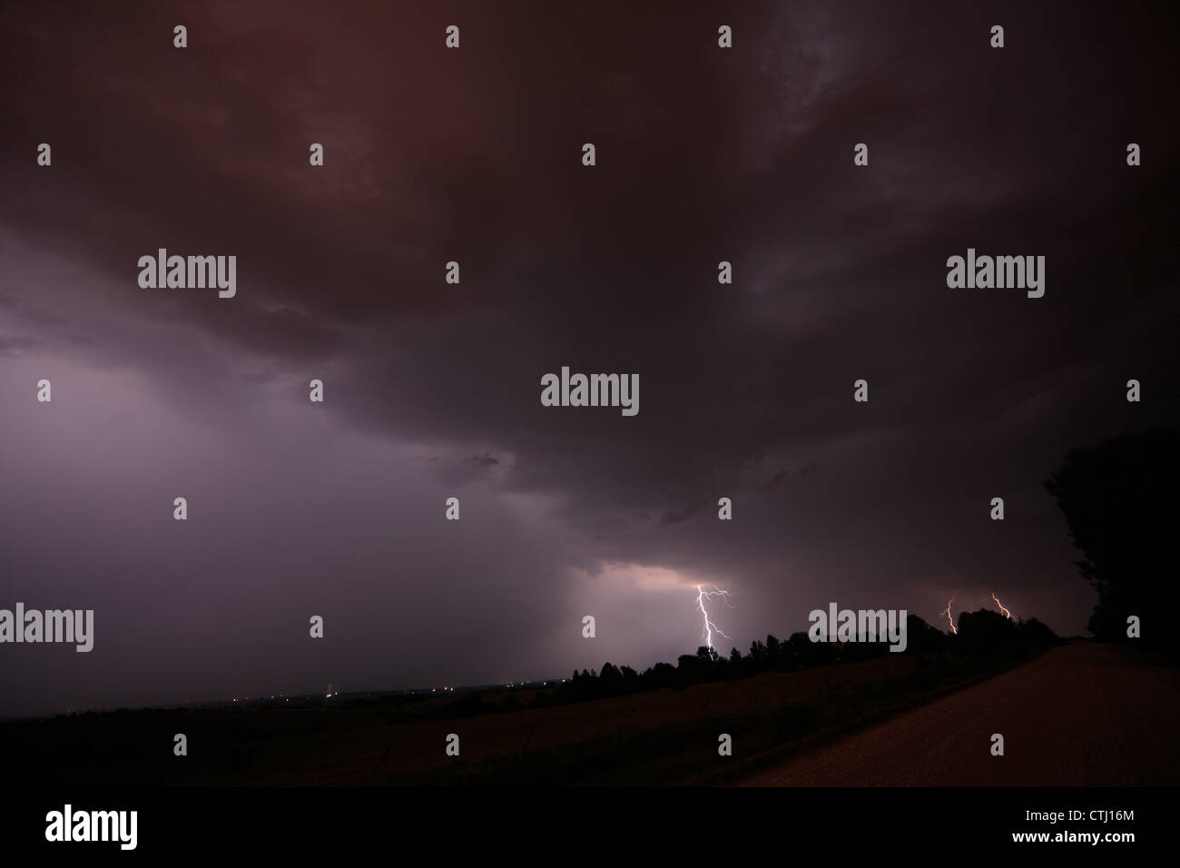 Lightning strikes far away during a night thunderstorm, with heavy rain ...