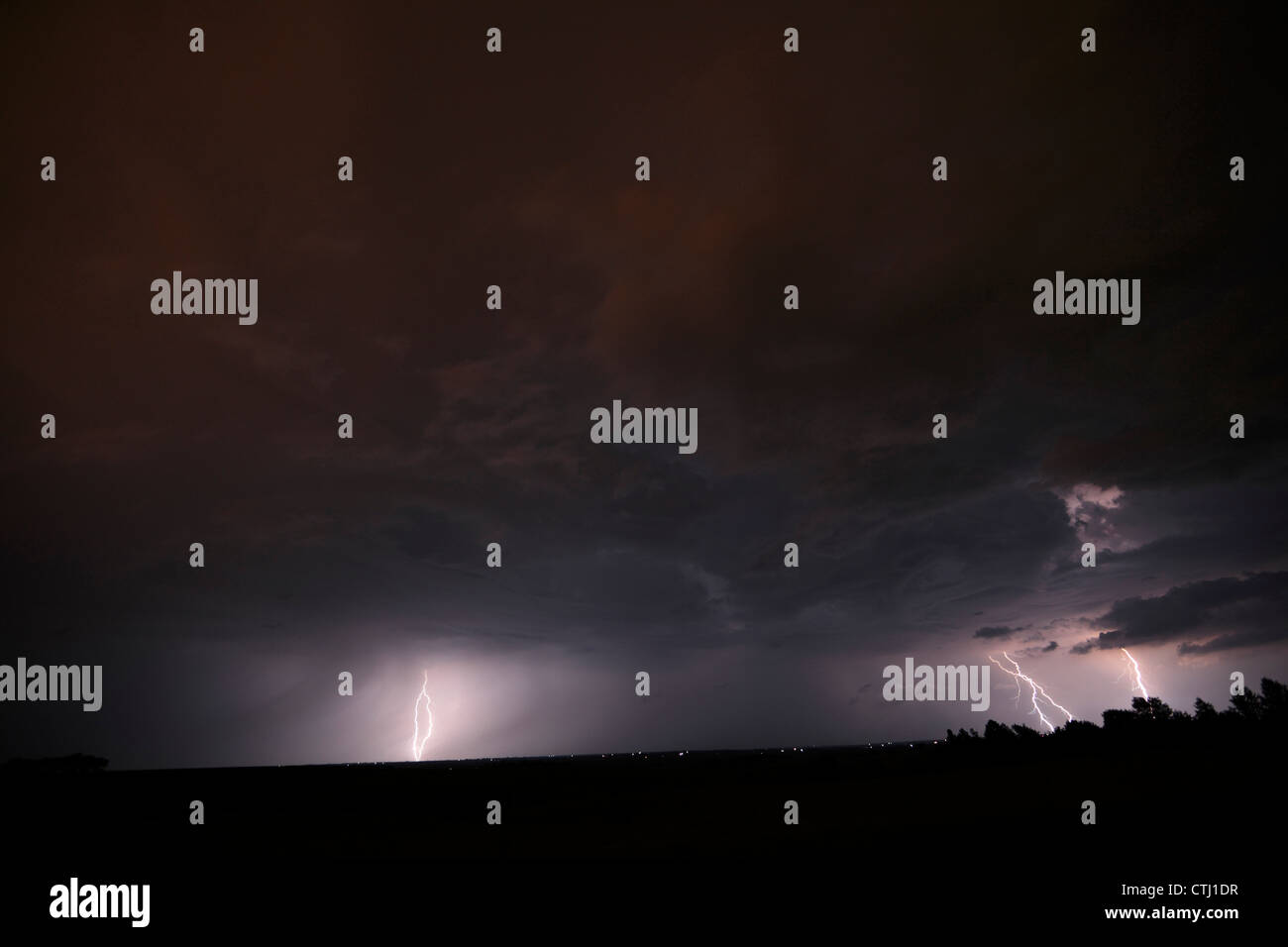 Triple lightning strike during a severe night thunderstorm Stock Photo ...