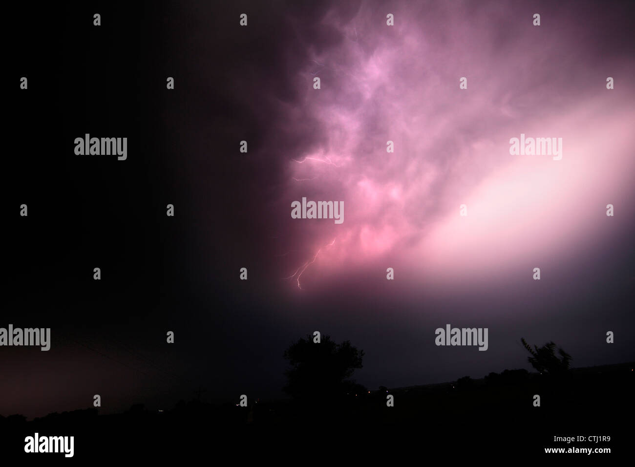 Lightning illuminates the trailing edge of a squall line thunderstorm ...