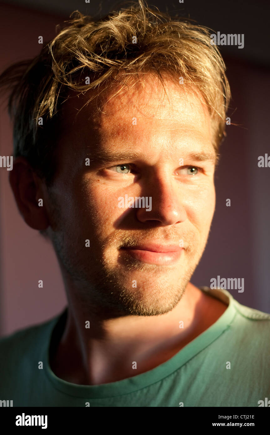 Young man in sunlight, smiling Stock Photo - Alamy
