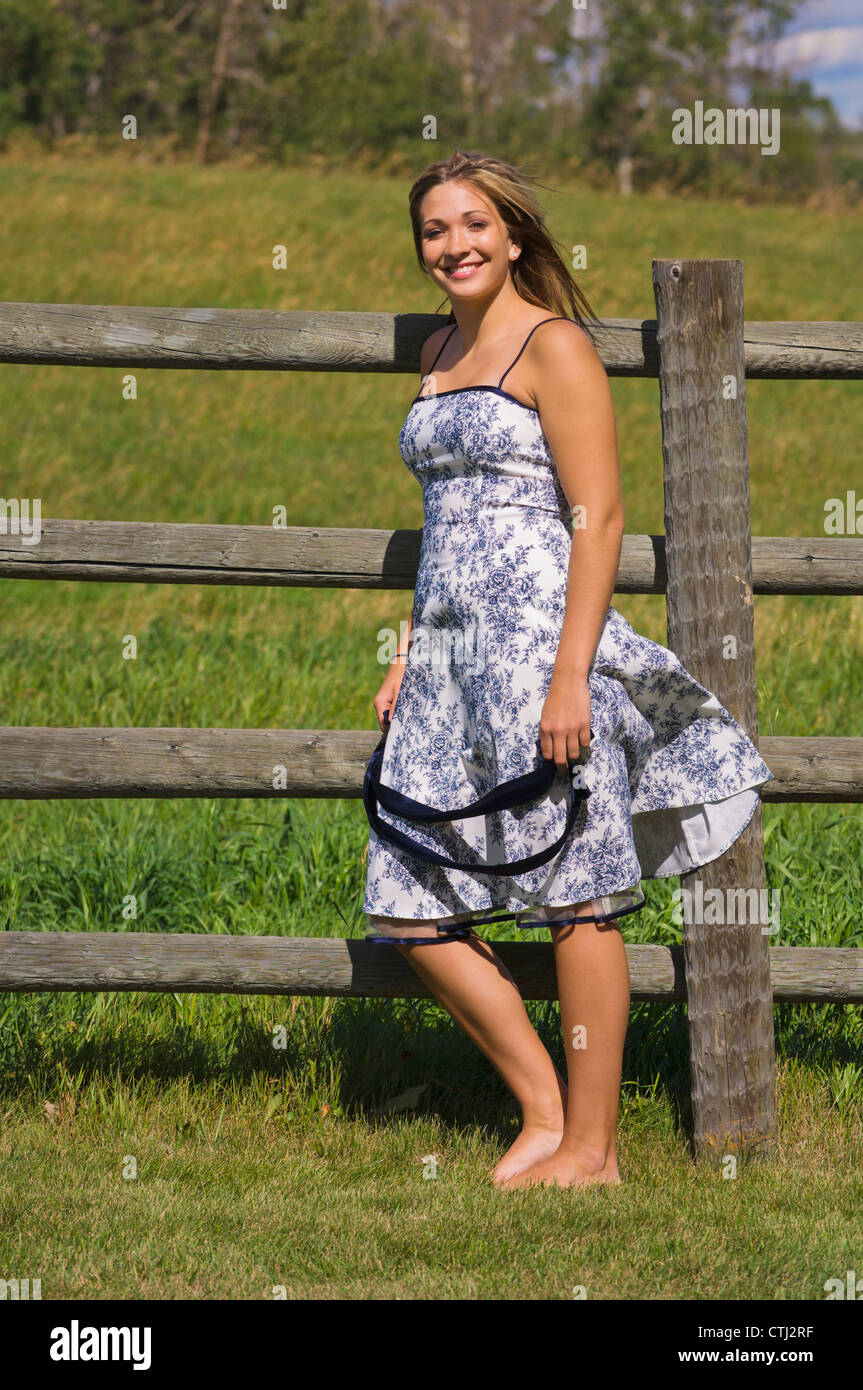 City Girl Standing By A Farm Fence; Edmonton, Alberta, Canada Stock ...
