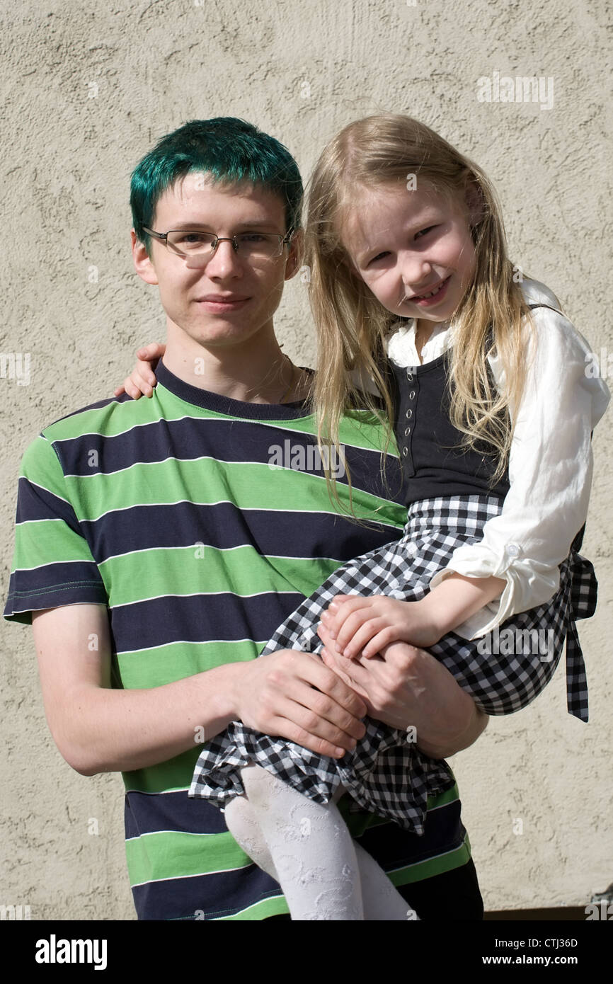 little fair-haired sister on her big green-haired brother's hands Stock ...