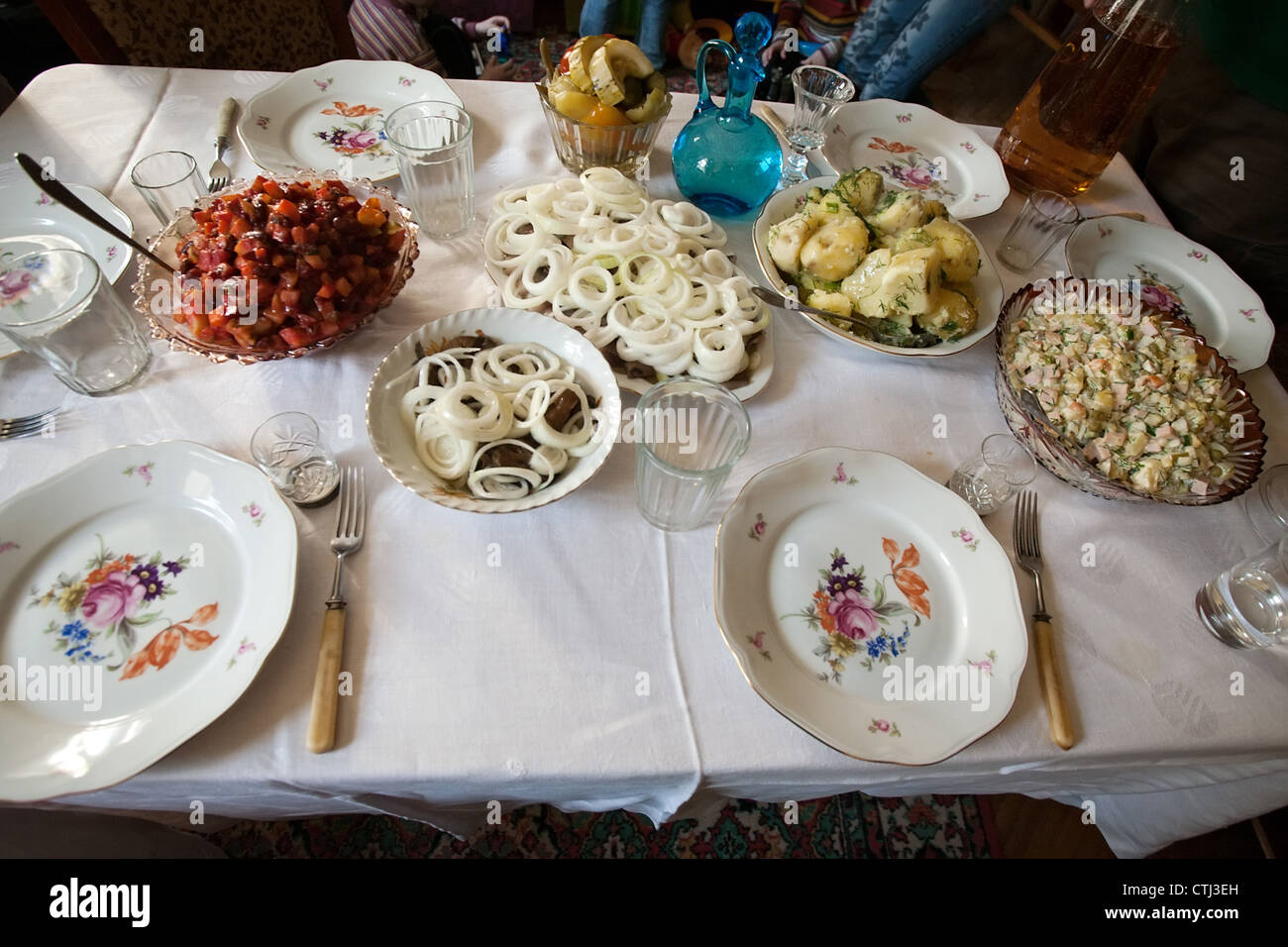 Russian holiday table with salads, potatoes, herring with onions ...