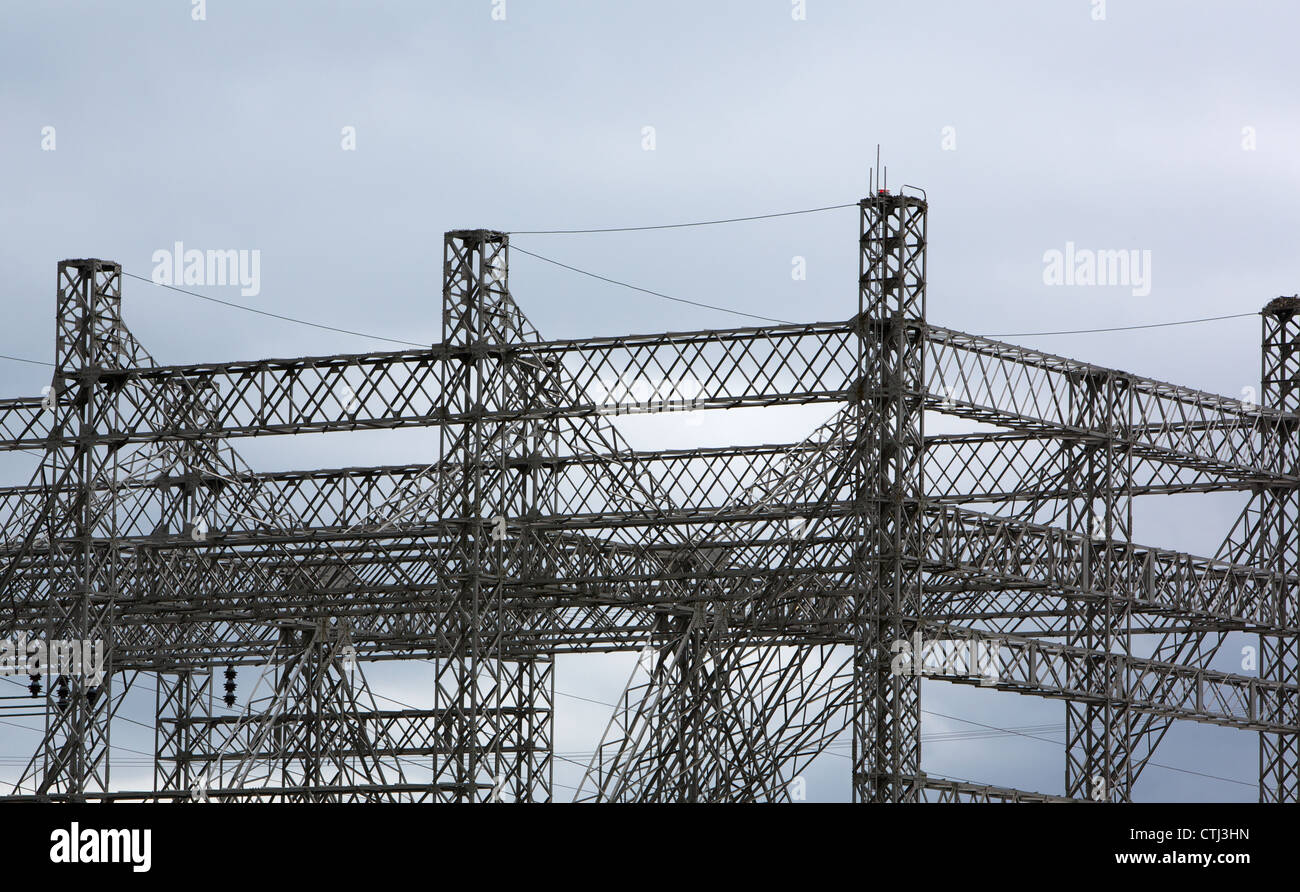 Complex steel structure of electrical power grid against cloudy sky ...