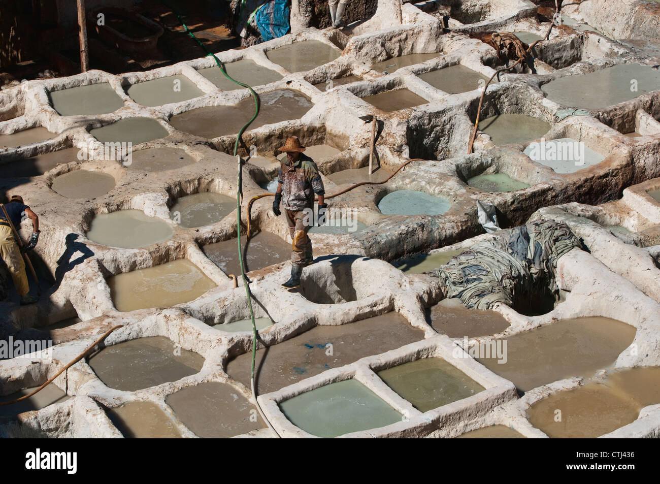 worker in the thousand year old leather tannery in the ancient medina ...