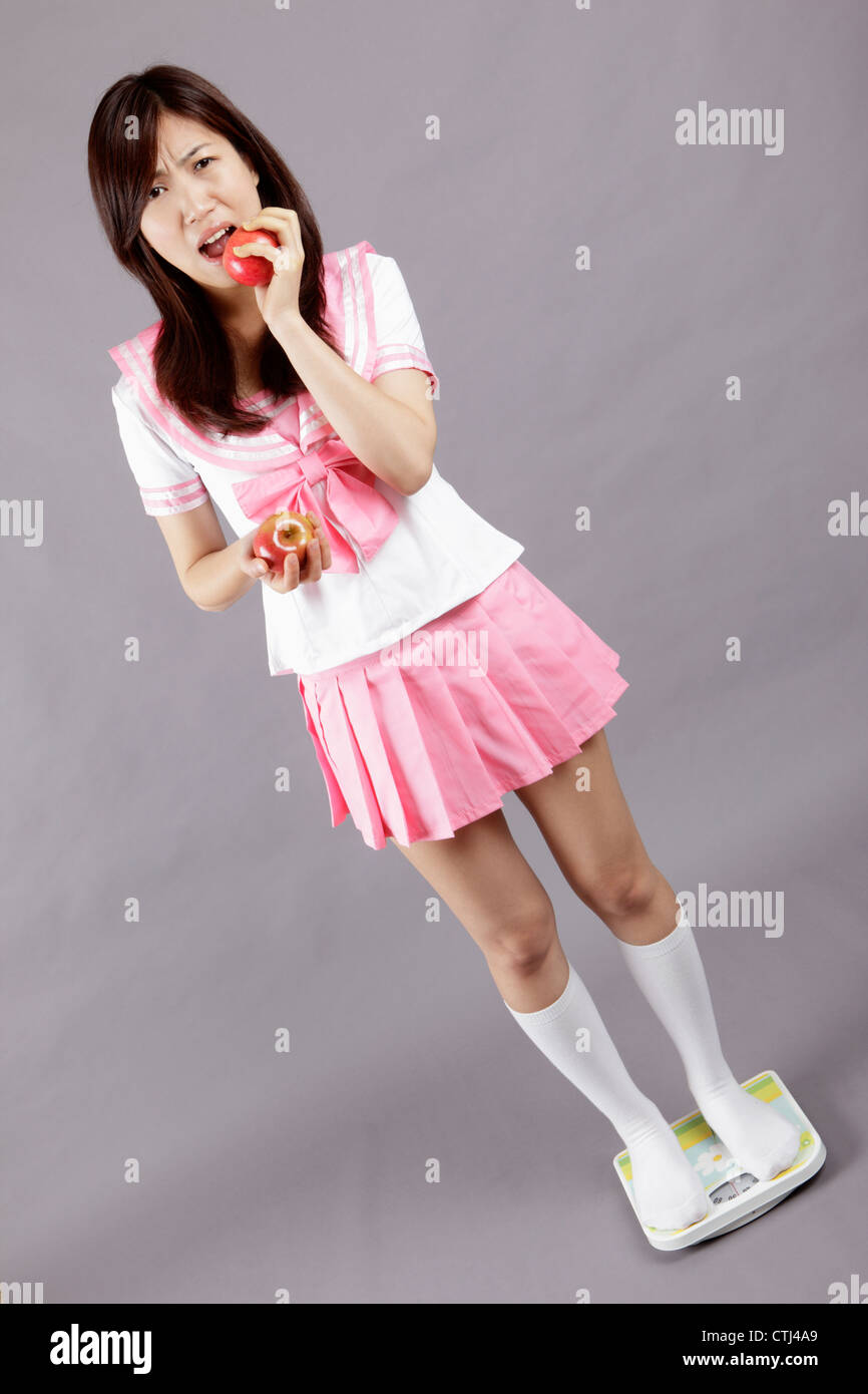 School girl is not happy with weight meter Stock Photo - Alamy