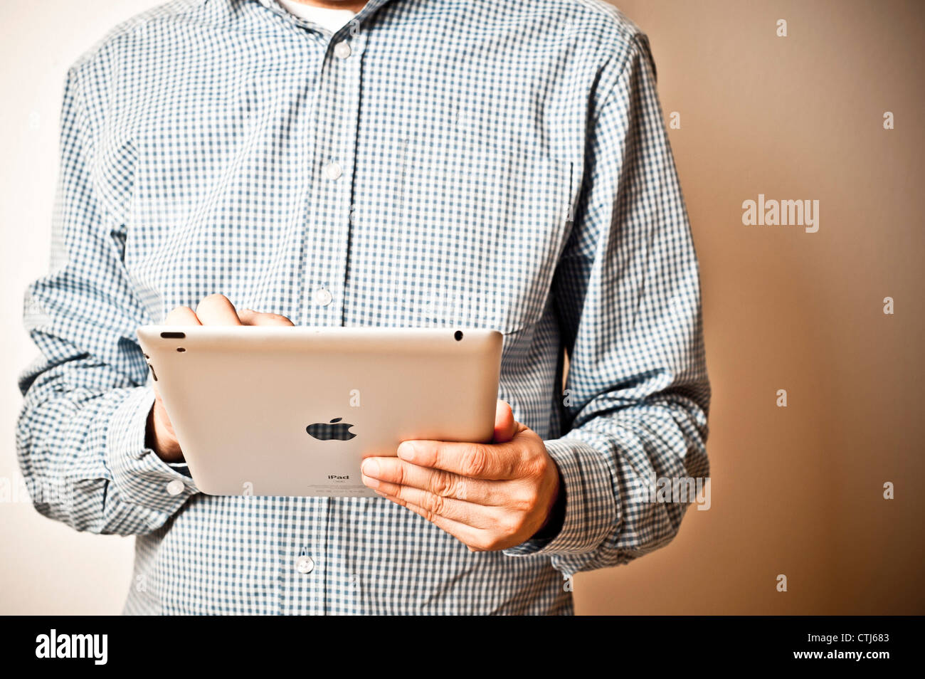 man using an iPad tablet Stock Photo - Alamy
