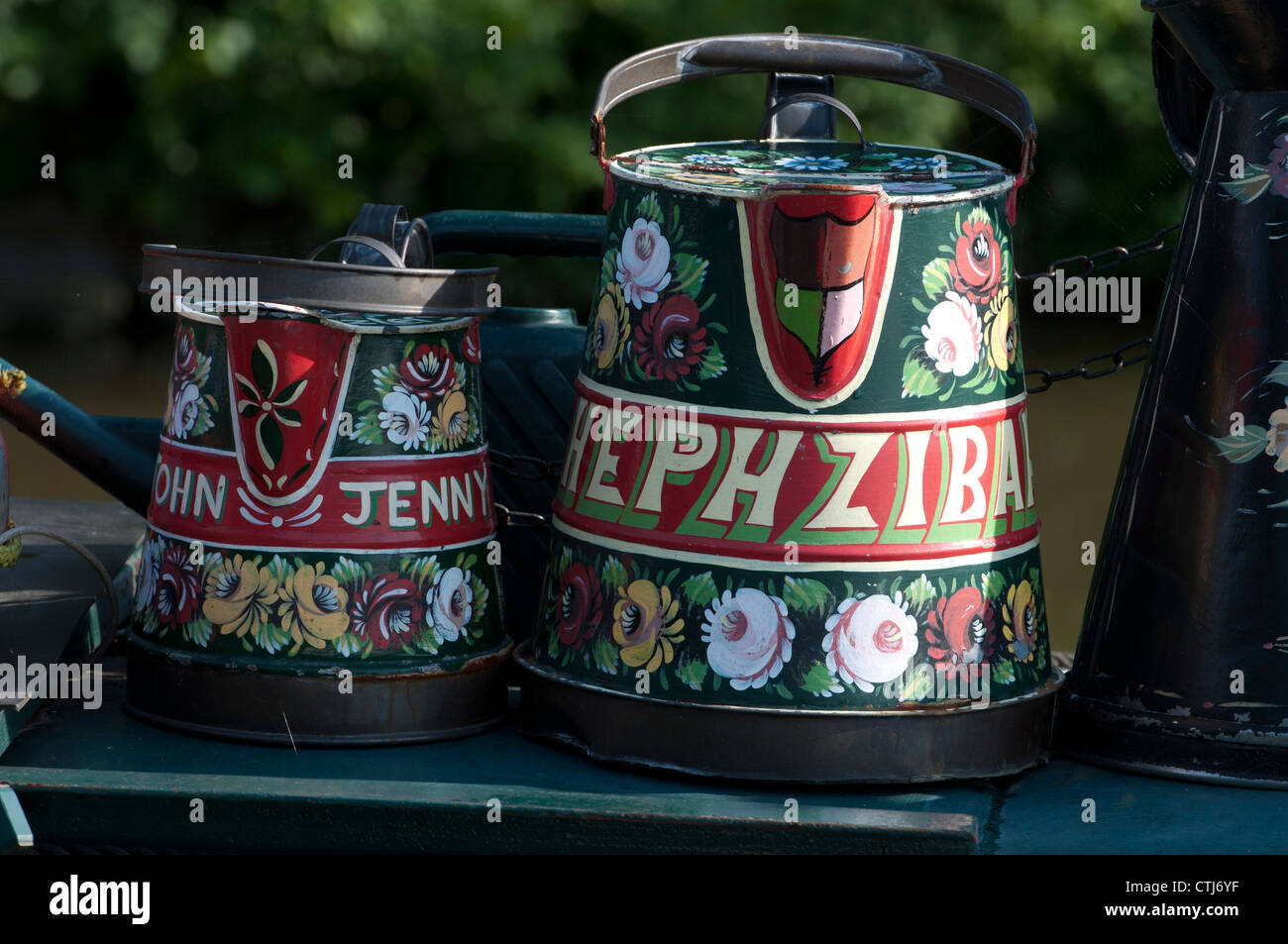 Painted Buckby cans on narrowboat Stock Photo - Alamy