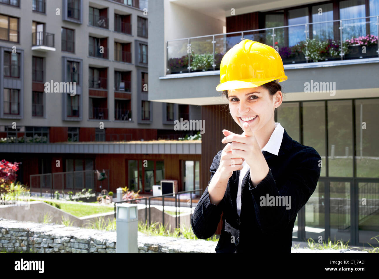 Female construction engineer show building in background Stock Photo ...