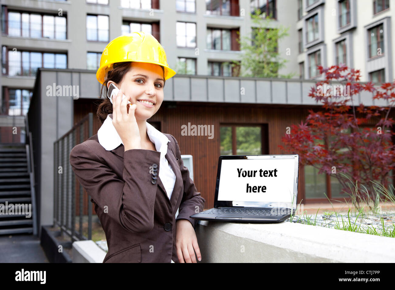Female construction engineer show something on laptop Stock Photo - Alamy