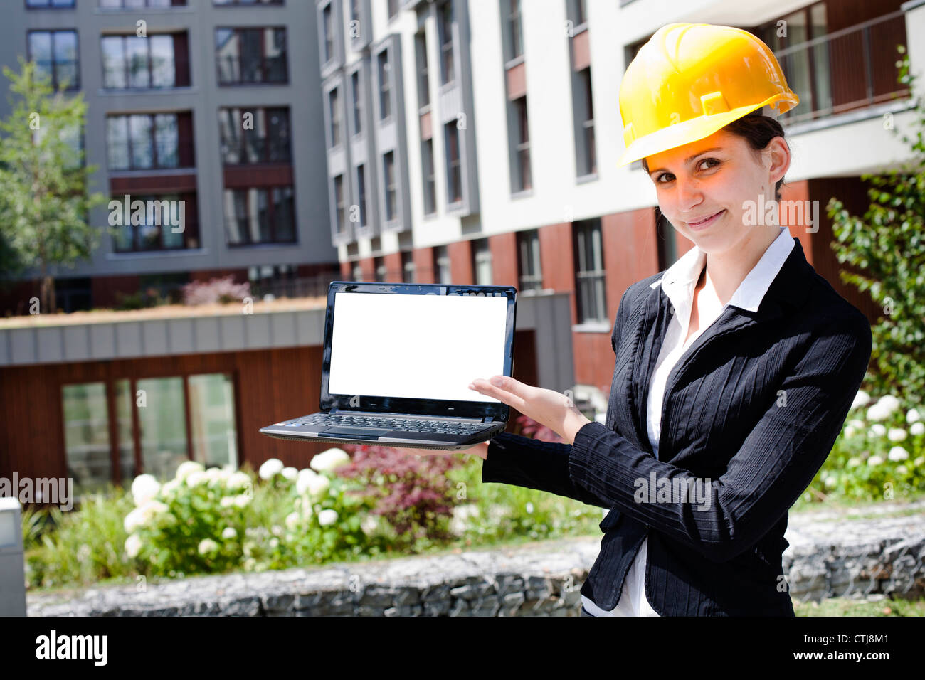 Female construction engineer show something on laptop Stock Photo - Alamy