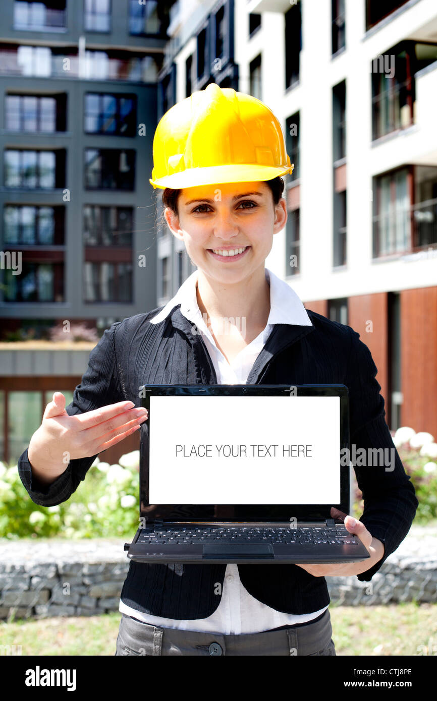 Female construction engineer show something on laptop Stock Photo - Alamy