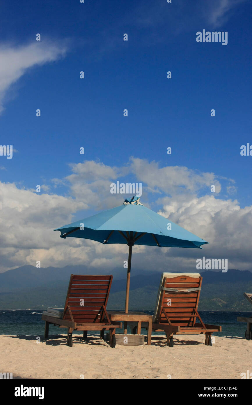 Sun chairs and umbrella on a beach Stock Photo - Alamy