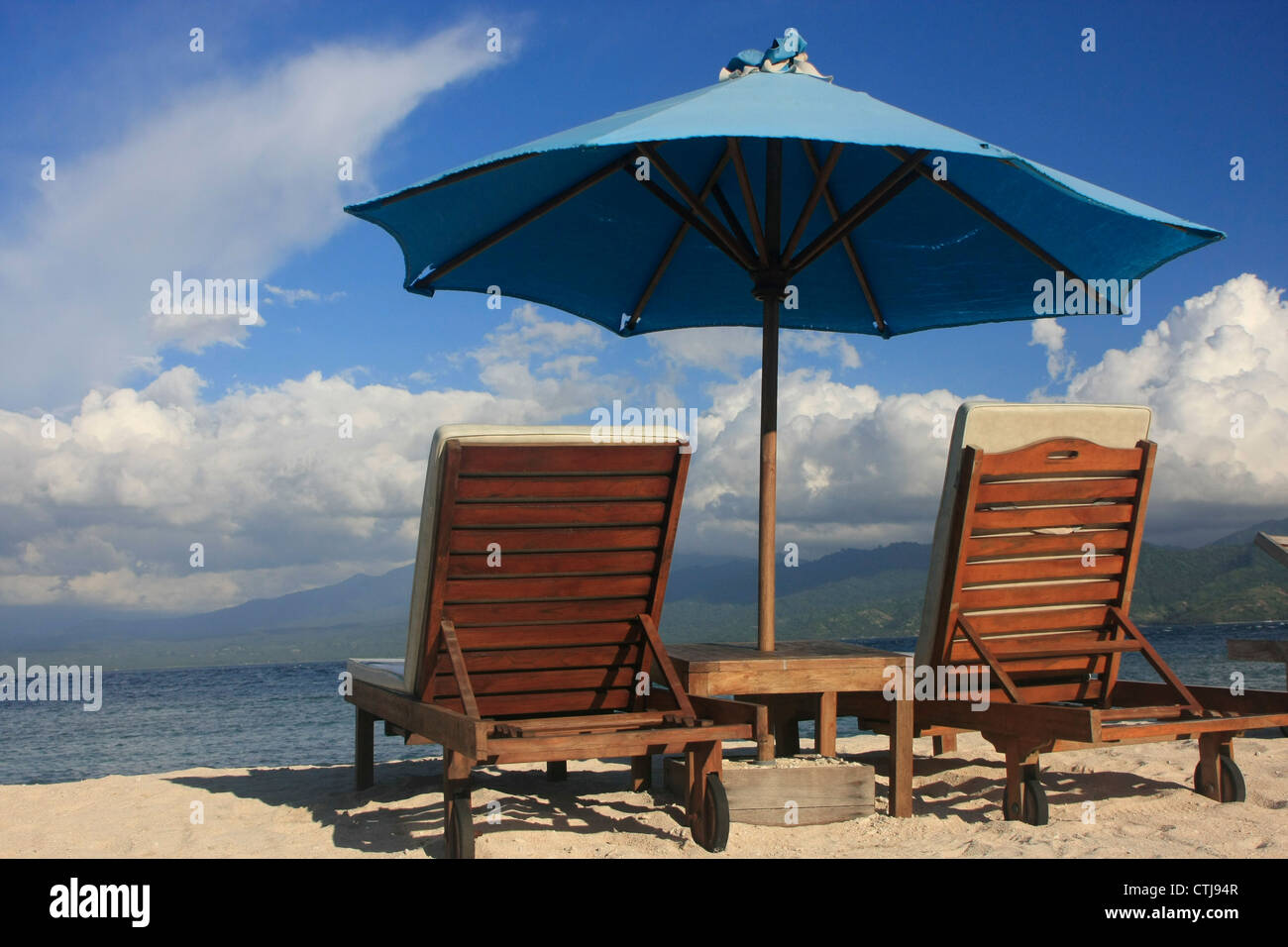 Sun chairs and umbrella on a beach Stock Photo - Alamy