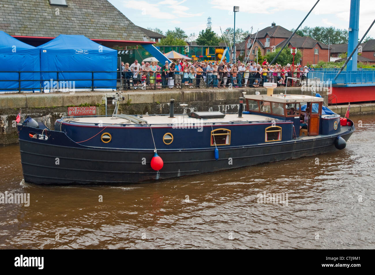 Crowds attending the annual Riversway Marine Festival watch as a barge ...