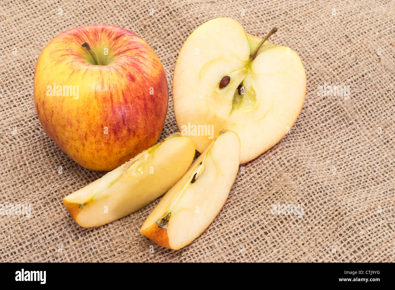 Apple with slices on a textile background Stock Photo - Alamy