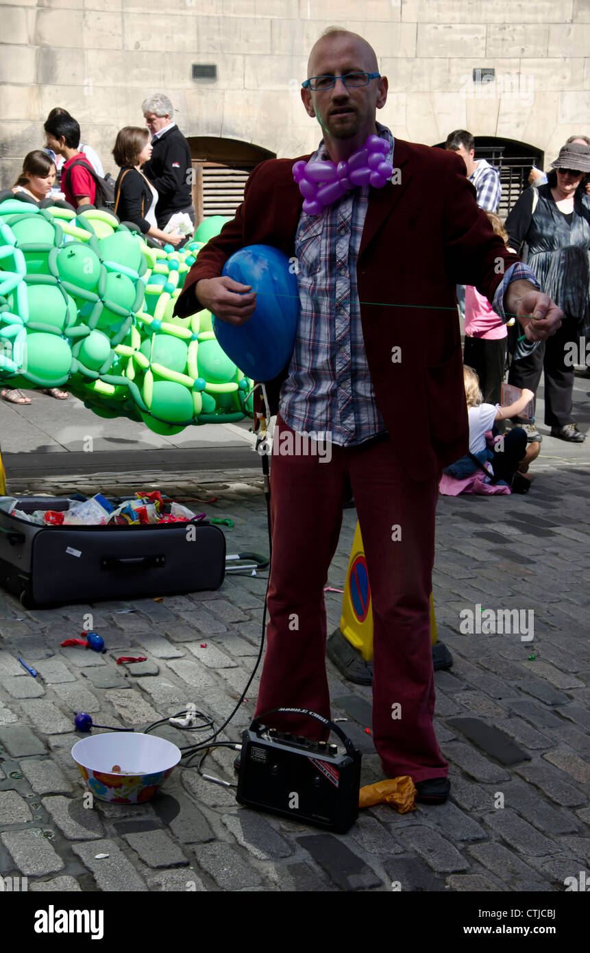 Man playing a musical instrument made from balloons in Central ...