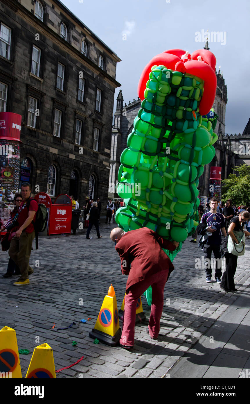 Man with a large dragon made from balloons in Central Edinburgh ...