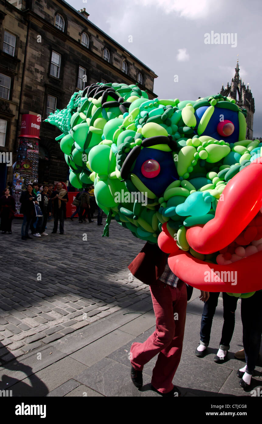 Man with a large dragon made from balloons in Central Edinburgh ...