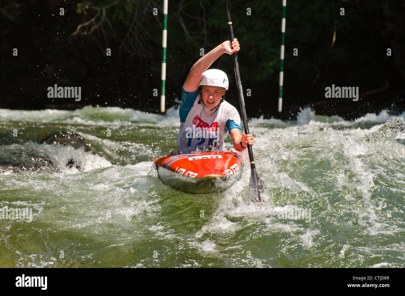 Kayaker in a whitewater slalom race Stock Photo - Alamy