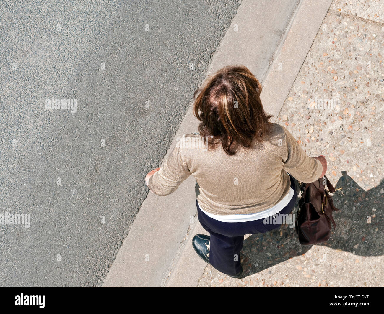 Overhead view of woman standing on pavement - France Stock Photo - Alamy