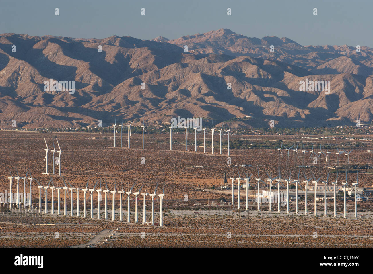 Large Windmill Farm In A Desert Valley With Desert Mountain Range In ...