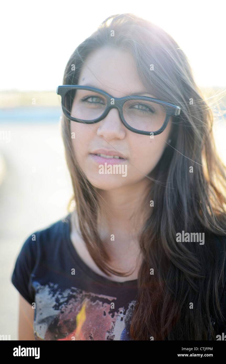 Cute young woman wearing black-rimmed glasses Stock Photo - Alamy